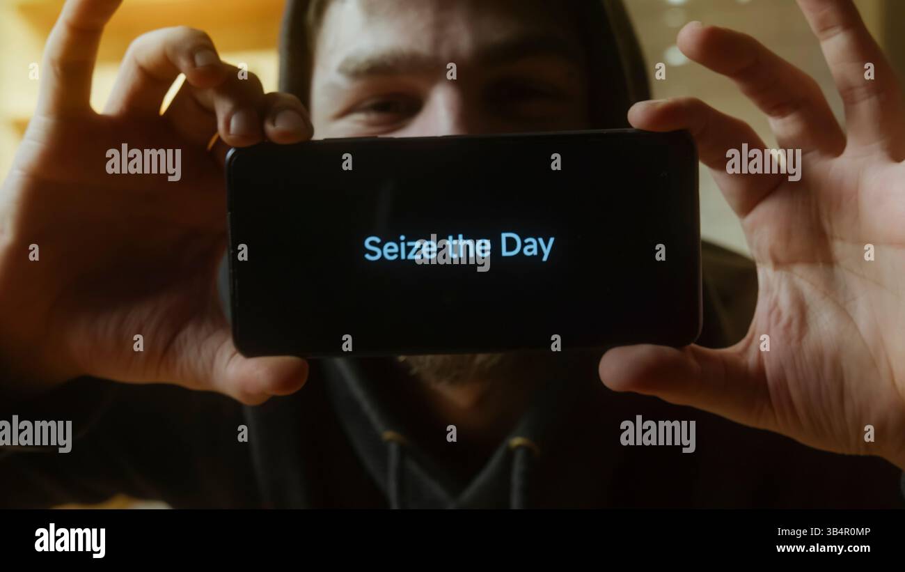 Excited Young Man Holding Smartphone with Seize the Day Message on ...