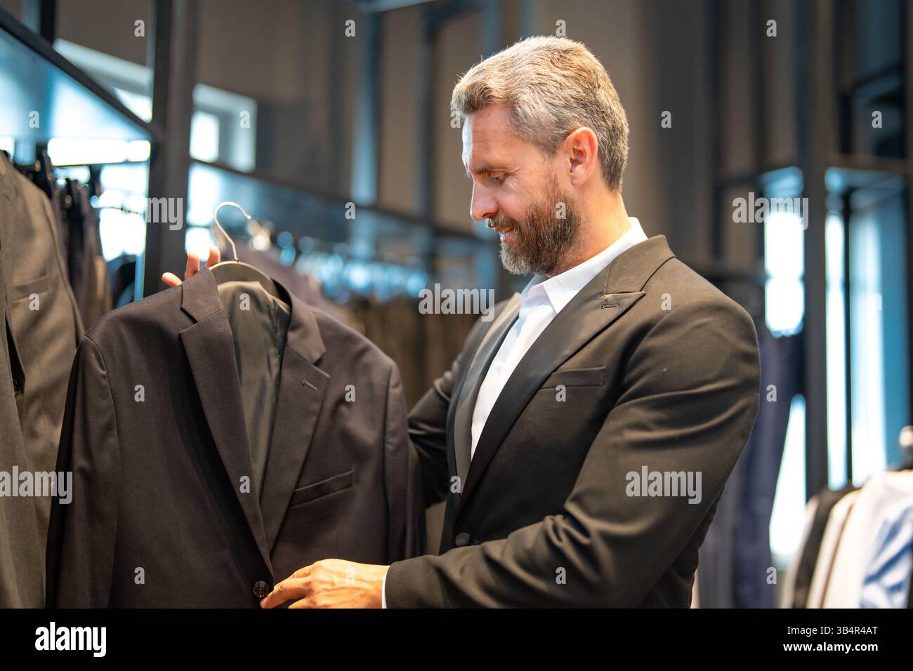 A man wears a classic tailored suit while shopping in a boutique. A ...