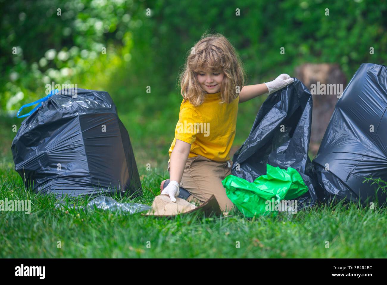 Child collecting trash outside. Ecology concept. Environmental ...
