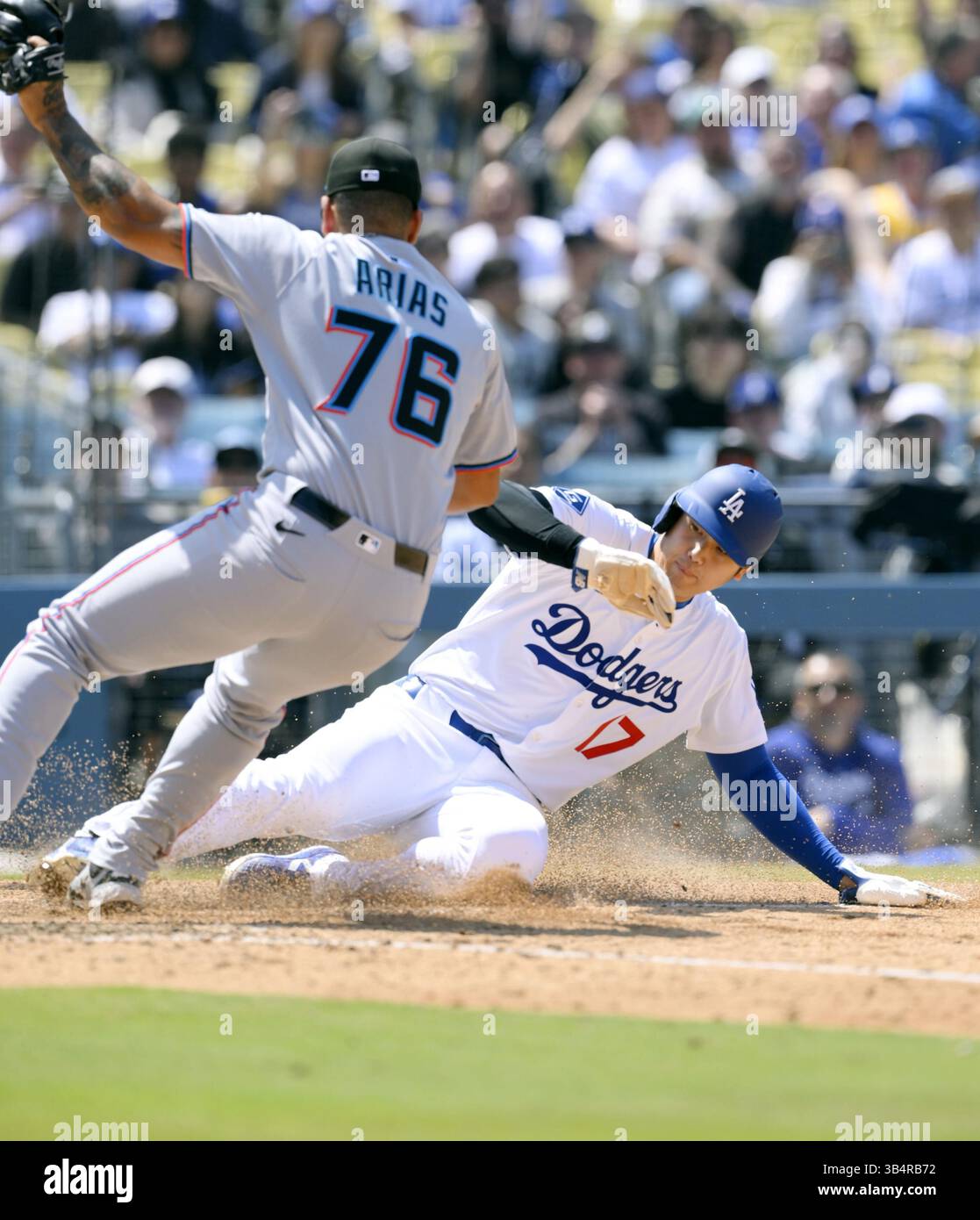 Los Angeles Dodgers designated hitter Shohei Ohtani (R) scores on a ...