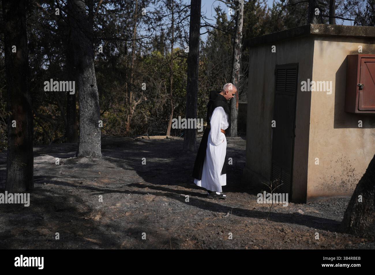 A Roman Catholic Trappist monk treads the scorched ground as Israeli ...