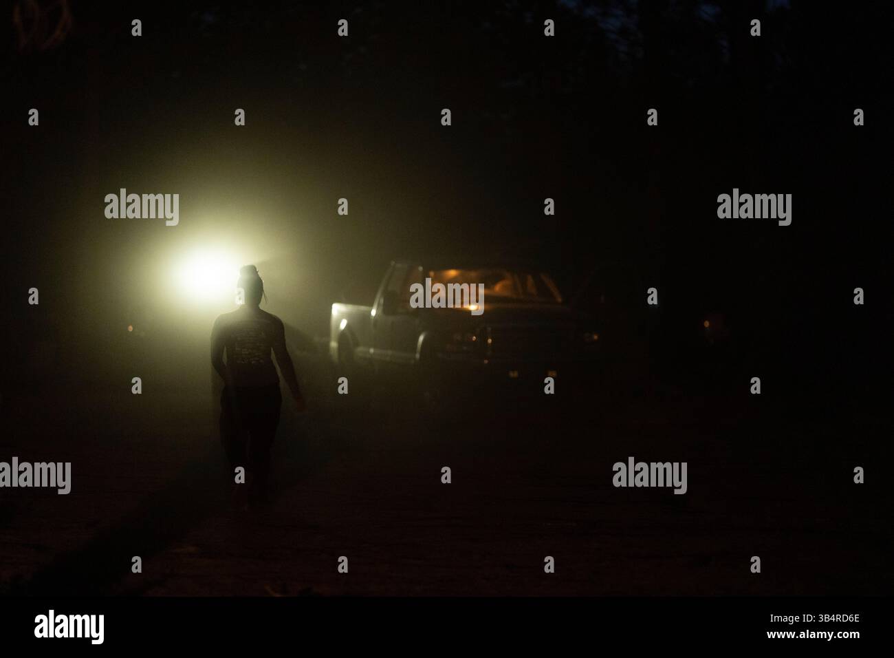 Mandy Bryant walks to help Mike Shelton with his trailer as they load ...
