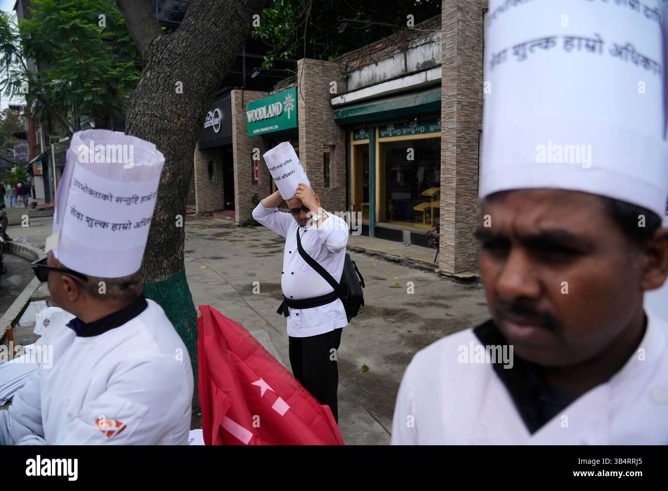 Workers affiliated with Communist Party of Nepal (Maoist Centre) get ready to participate in a ...