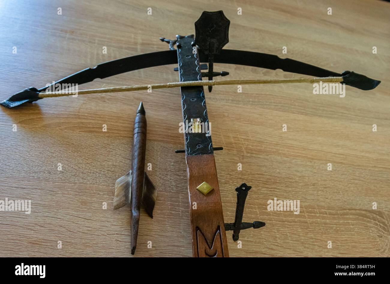 Decorative ancient wooden crossbow with arrow on a table Stock Photo ...