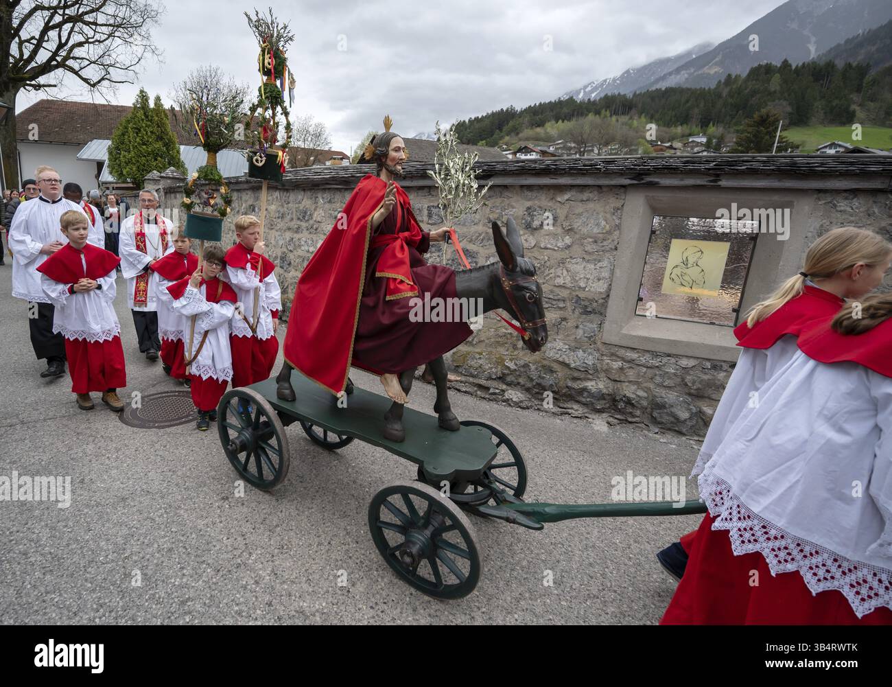 Altar servers preparing for the palm tree procession in the parish ...
