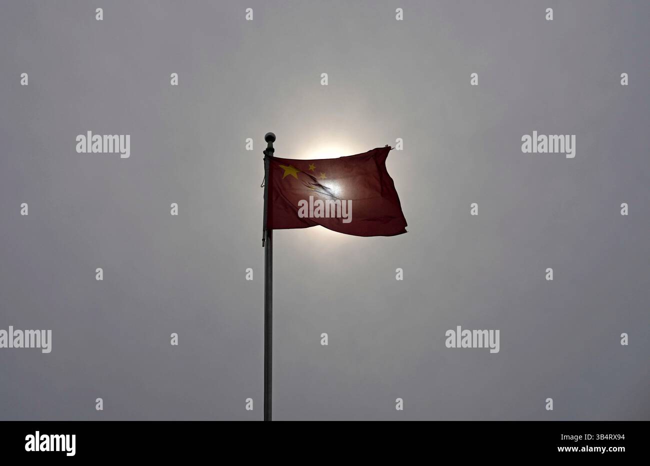 The national flag of China, known as the Five-Star Red Flag, is flown ...
