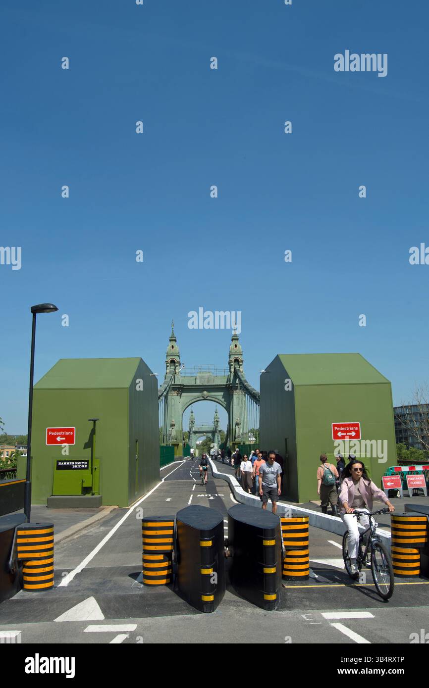 seen from the barnes side, cyclists and pedestrians cross hammersmith ...