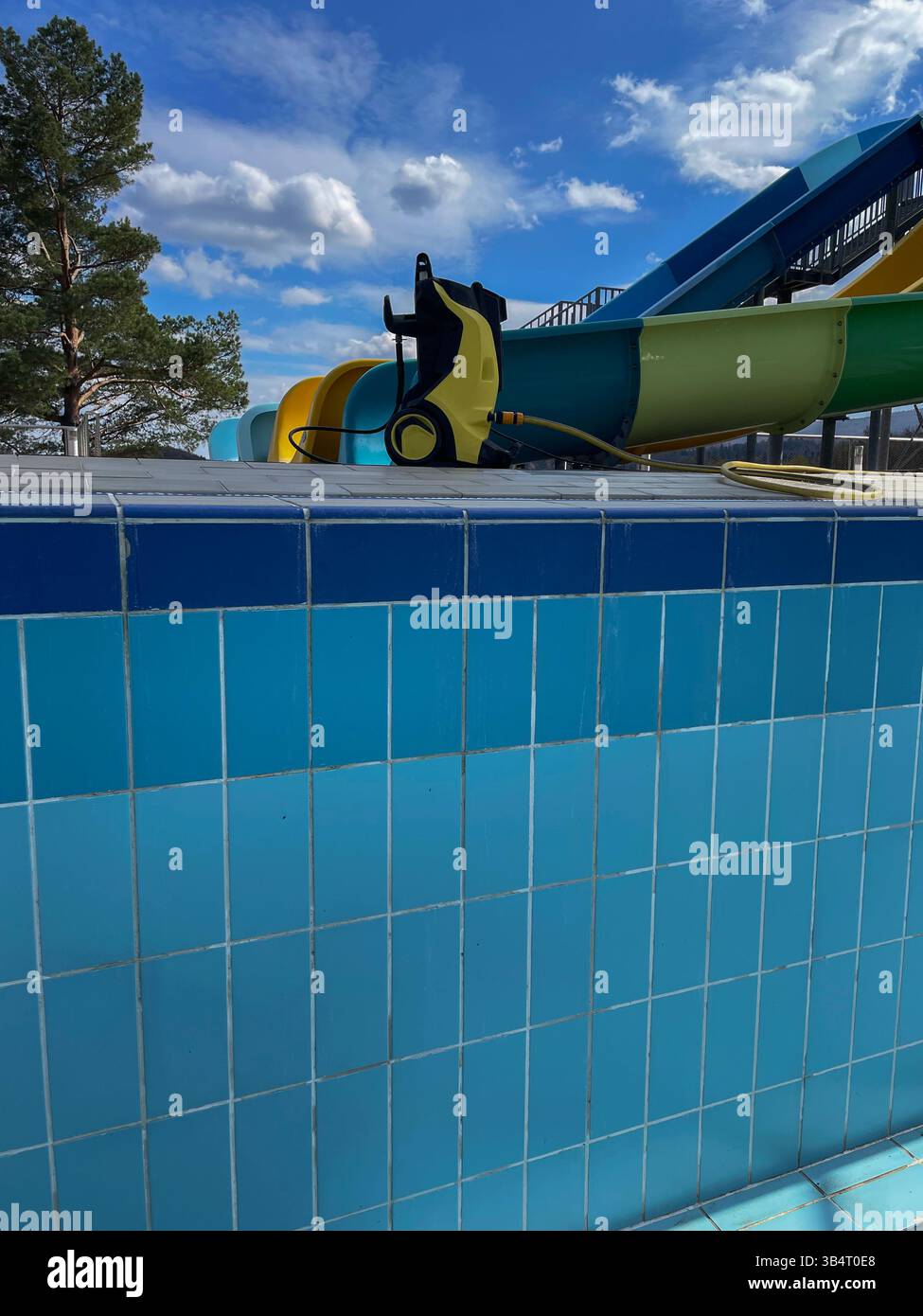 Cleaning the water park using a high-pressure washer.Washing the pool ...