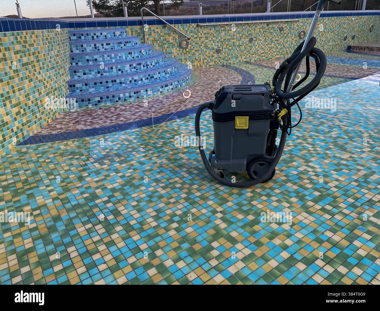 Cleaning the water park using a high-pressure washer.Washing the pool ...