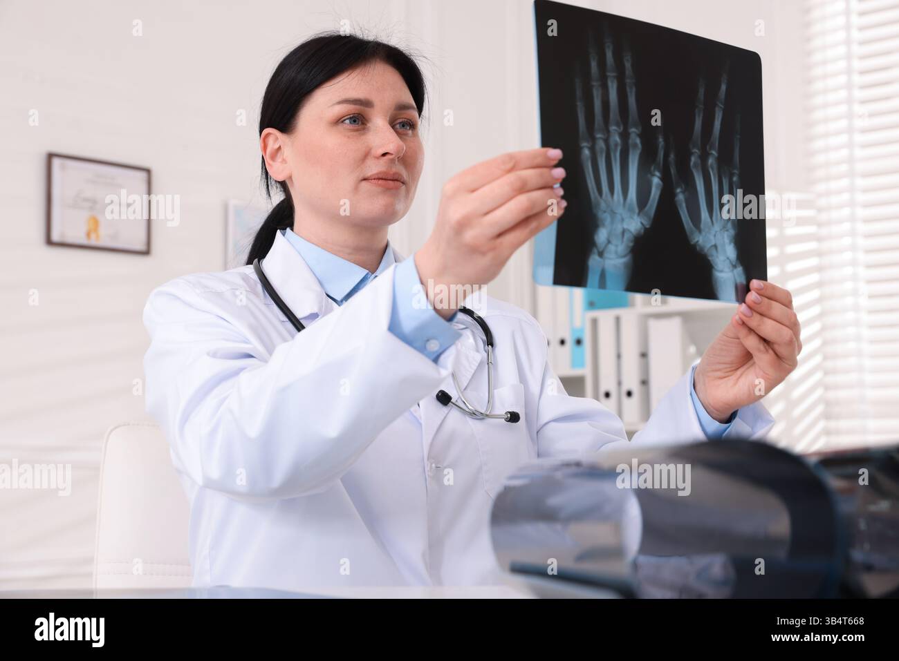 Doctor examining hand MRI scan in clinic Stock Photo - Alamy