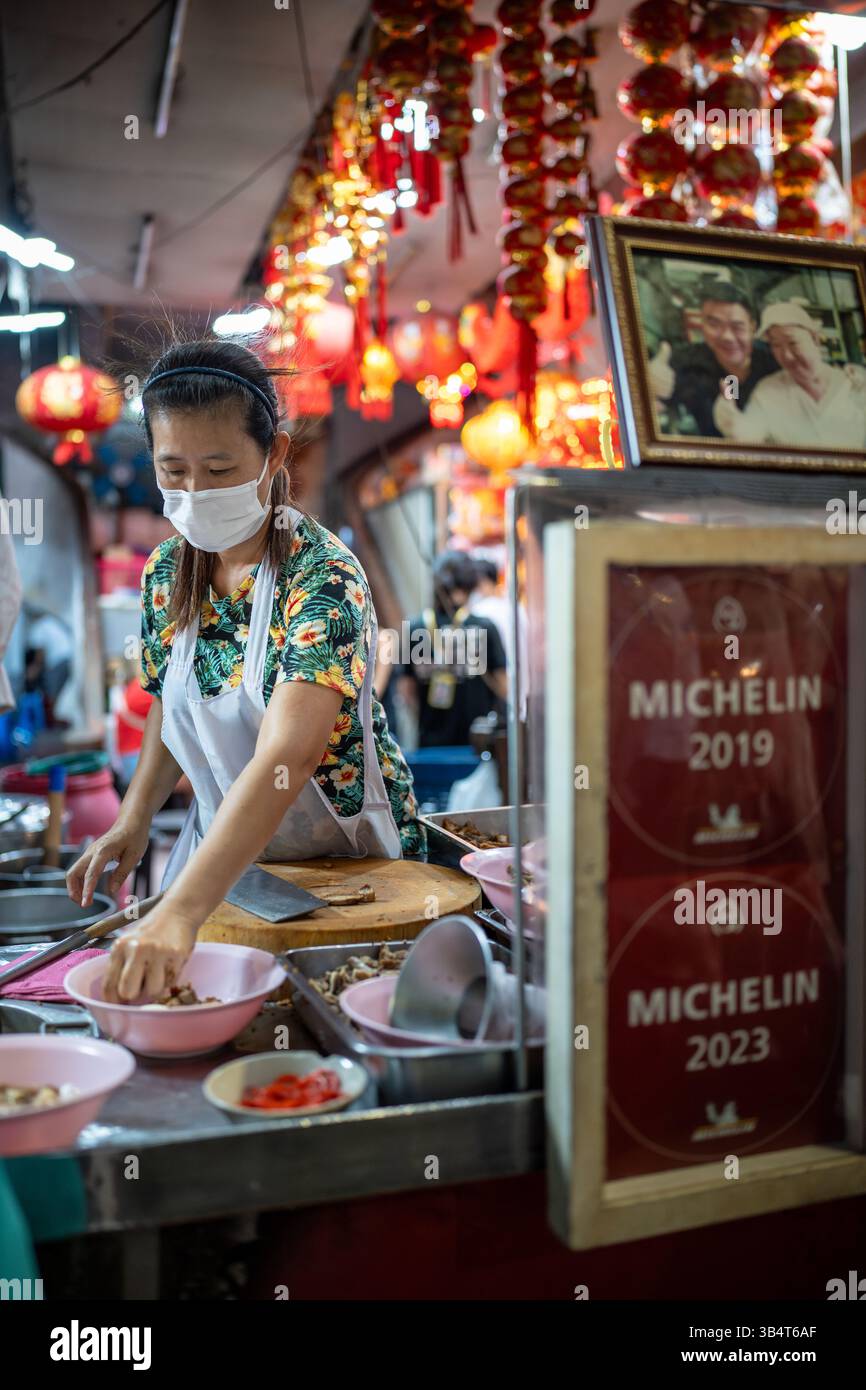 Thai woman wearing face mask cooking local food at food stall at ...