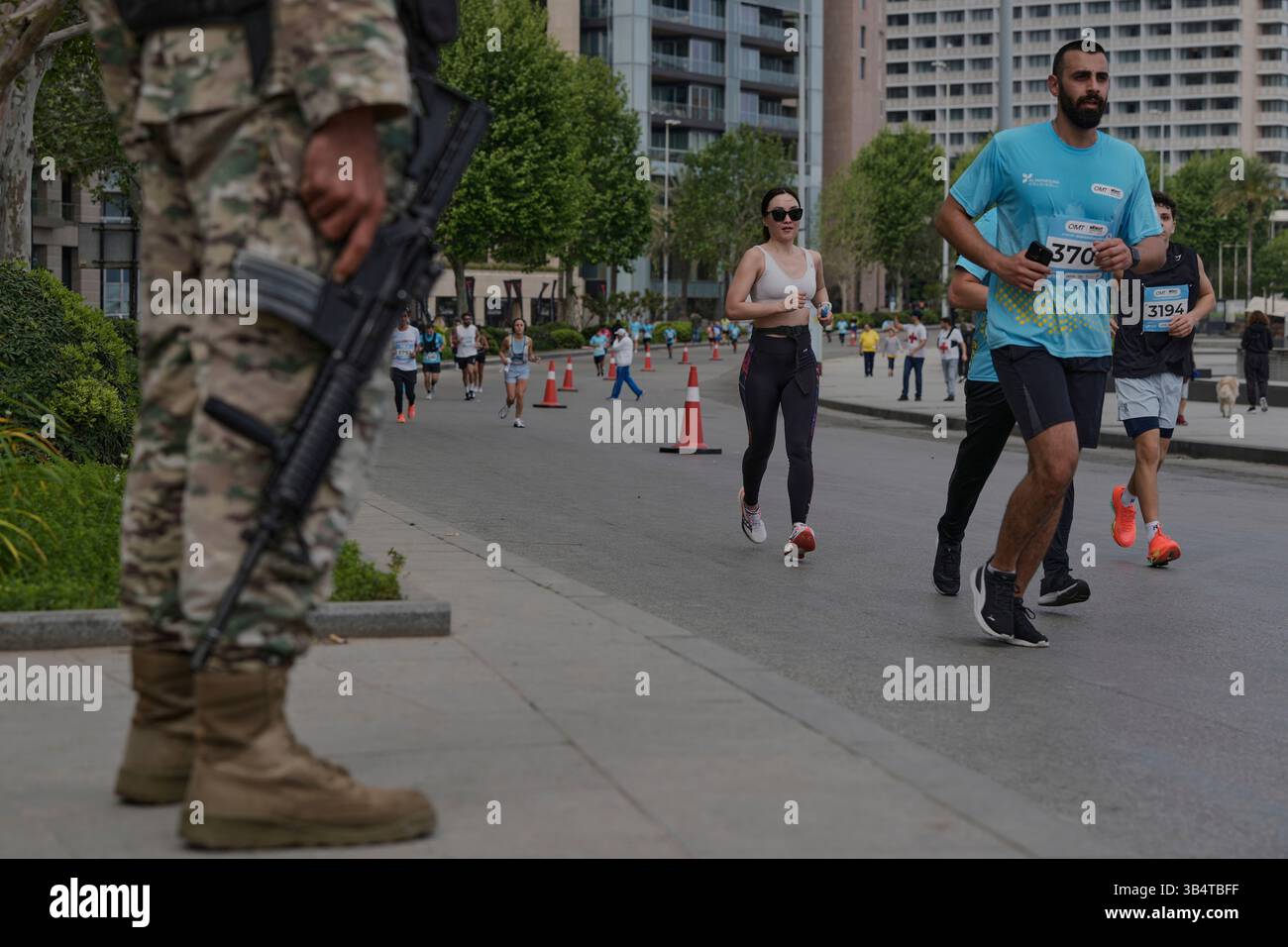 A Lebanese army soldier stands guard as runners compete in the 10 ...