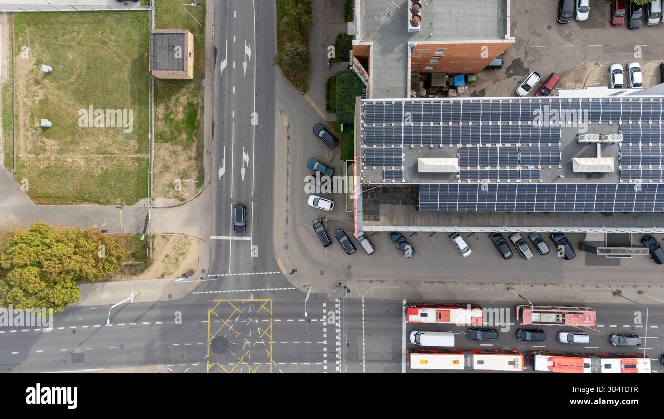 Aerial view of a city intersection with solar panels on a building roof ...