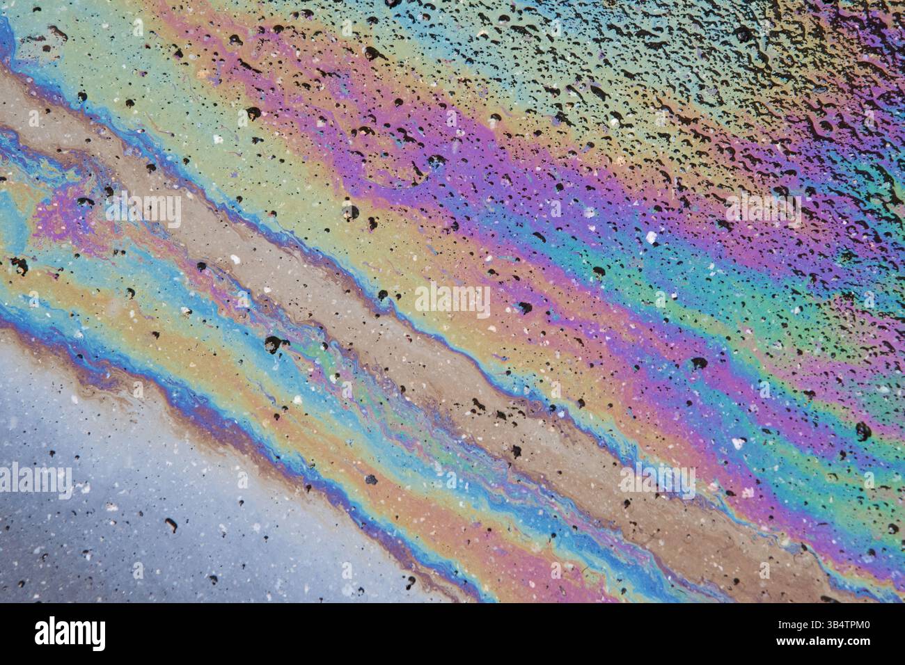 Petrol stain on asphalt road, big polluted puddle water Stock Photo - Alamy