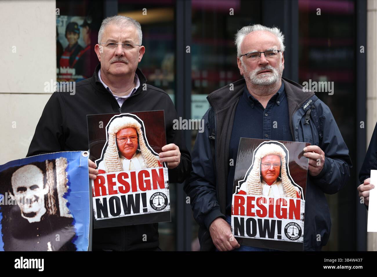 Campaigners hold images of Lord Chief Justice Sir Declan Morgan during ...