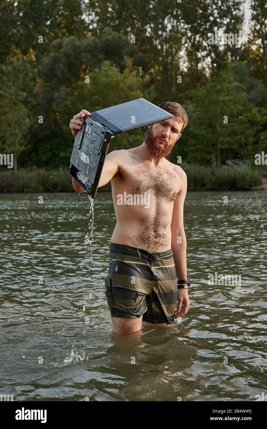 Using work laptop on the beach, device fallen in water Stock Photo - Alamy