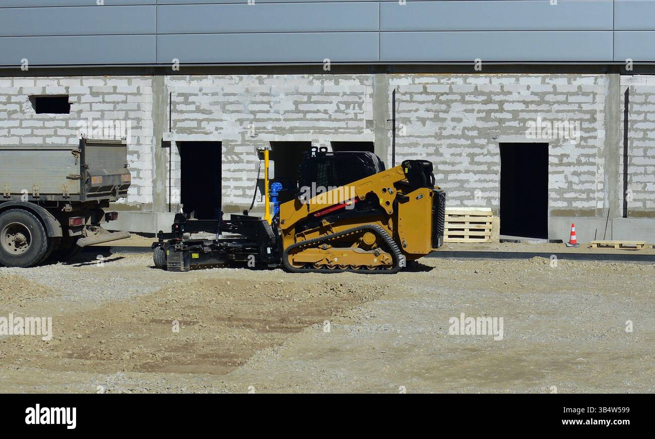 Mini caterpillar excavator standing in big construction site. Small ...
