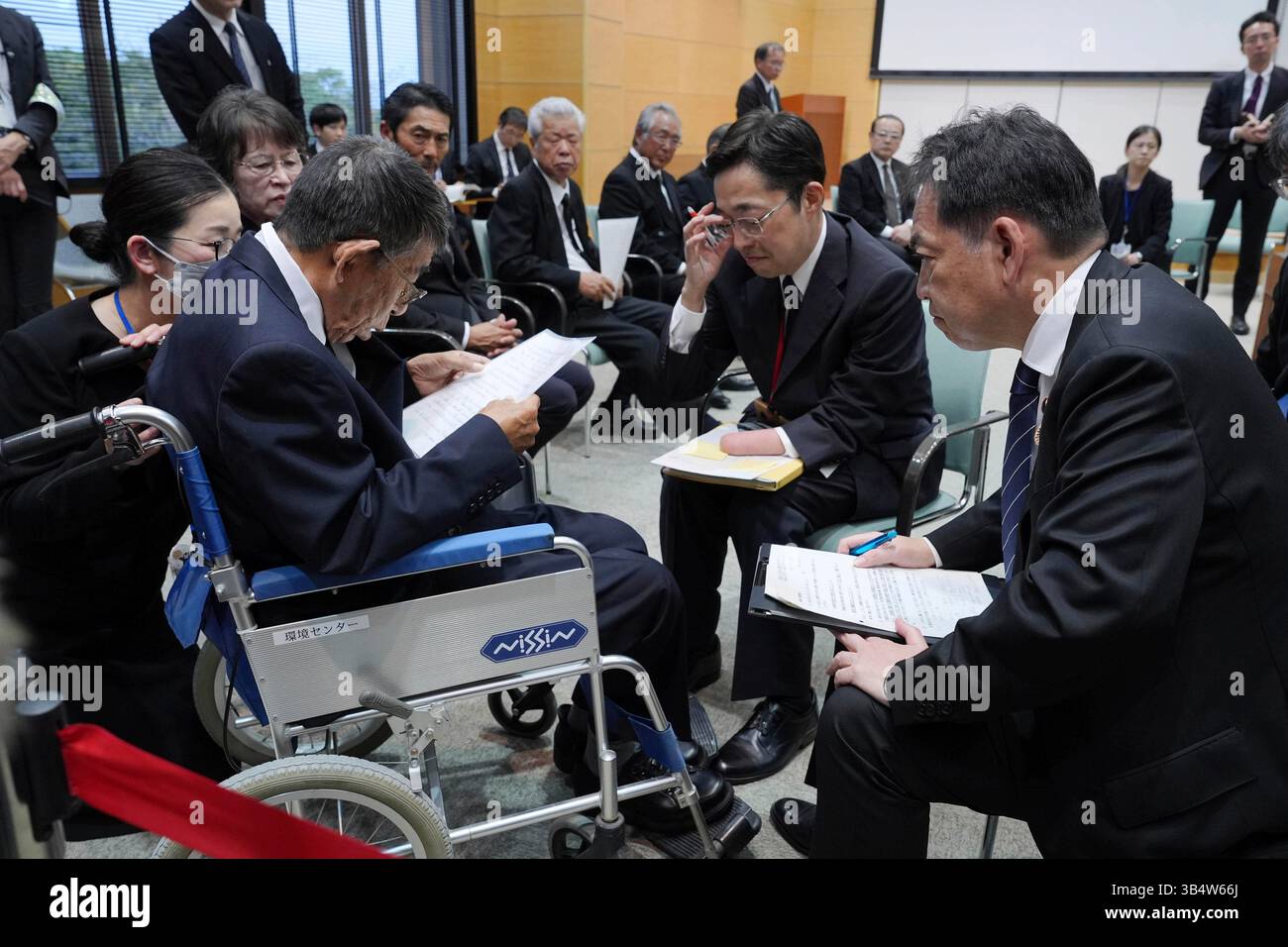 Japanese Environment Minister Keiichiro ASAO (R) attends a talk with ...