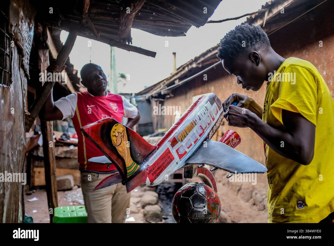 May 24, 2022, NAIROBI, KENYA: Bernard Omondi check on the process of his World Cup art designed ...