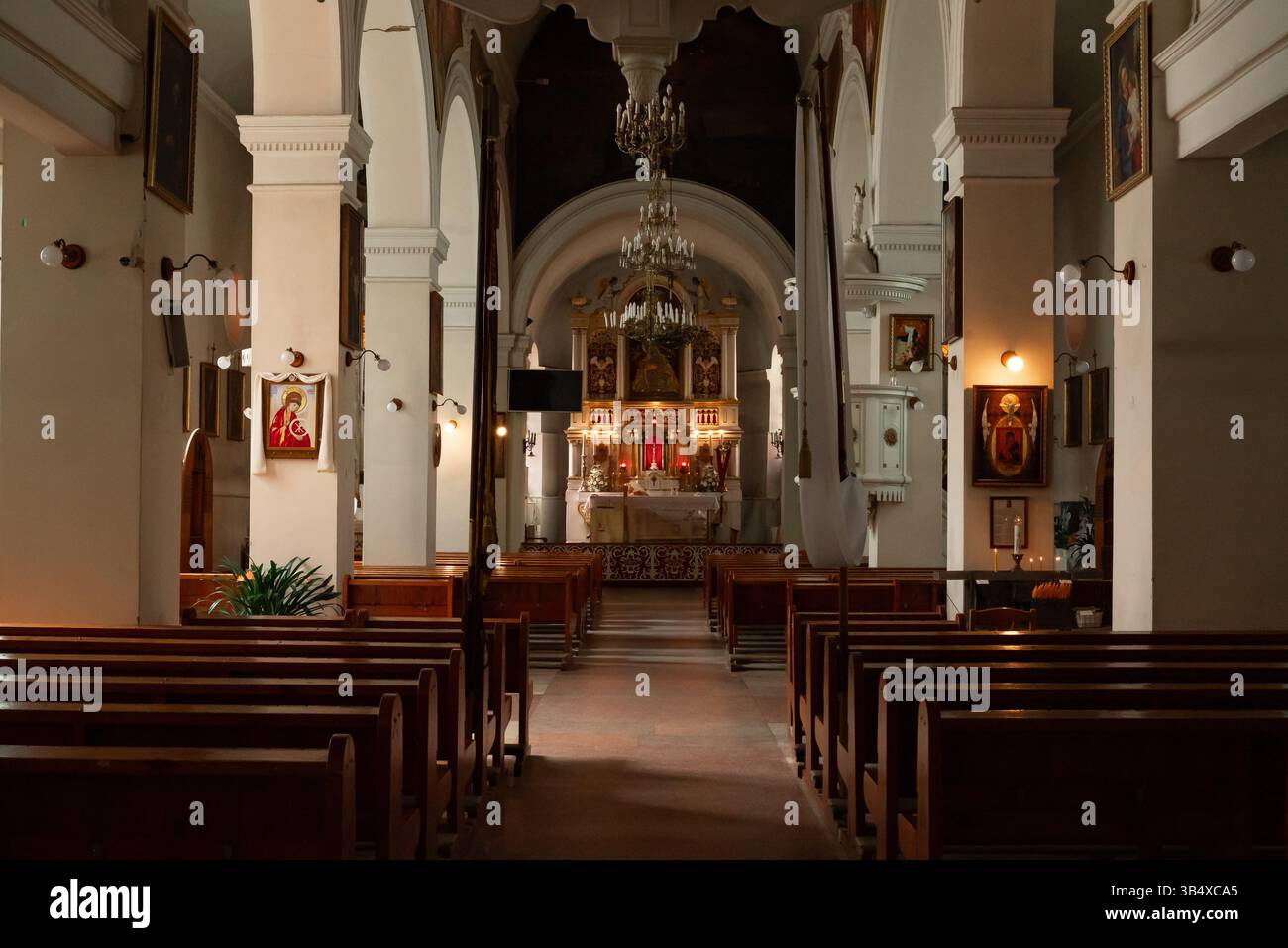 Interior of a church with a view of the altar and wooden pews. Sacred ...