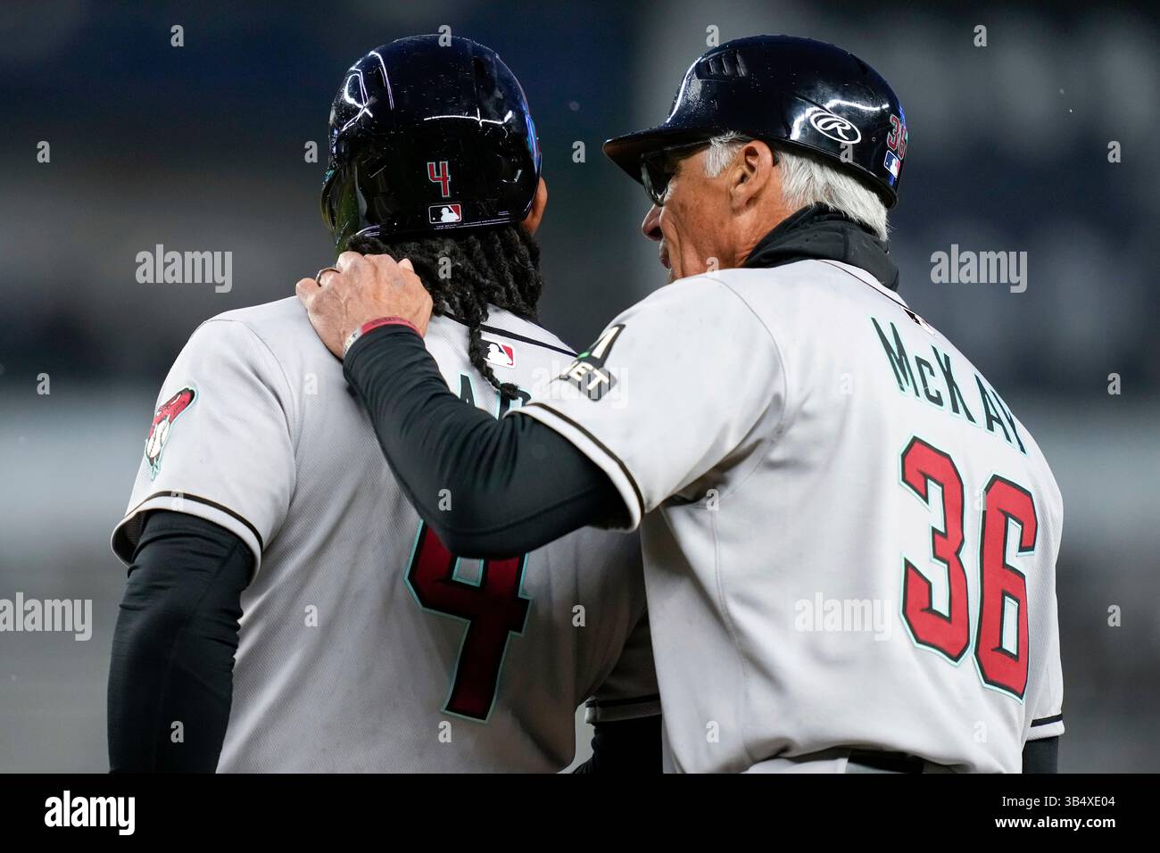 Arizona Diamondbacks first base coach Dave McKay (36), right, talks to ...