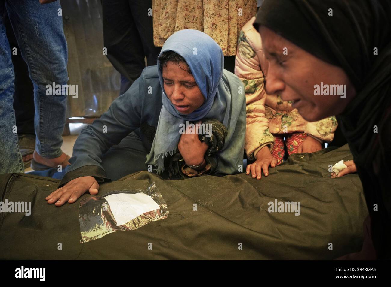 Islam Abu Sahloul mourns the death of her sister Lamia, 32, who was ...