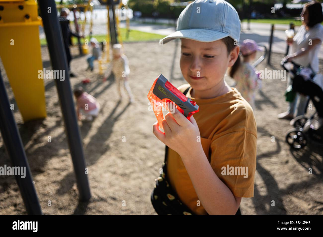 Child exploring with a toy while enjoying activities in a vibrant play ...