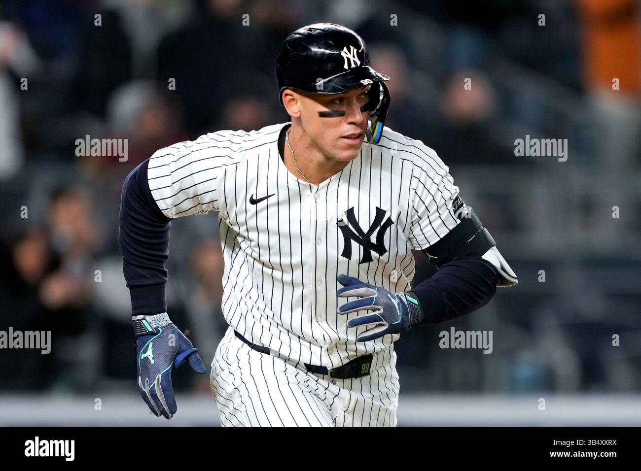 New York Yankees' Aaron Judge runs to first base after singling on a ...