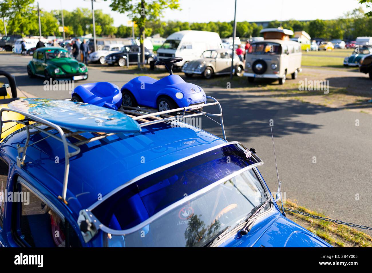 Hanover, Germany. 01st May, 2025. A toy car stands on the roof of a VW ...