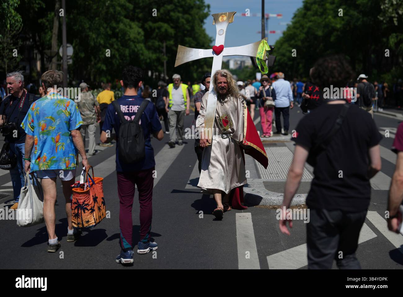A man dressed like Jesus and holding a cross attends the May Day ...