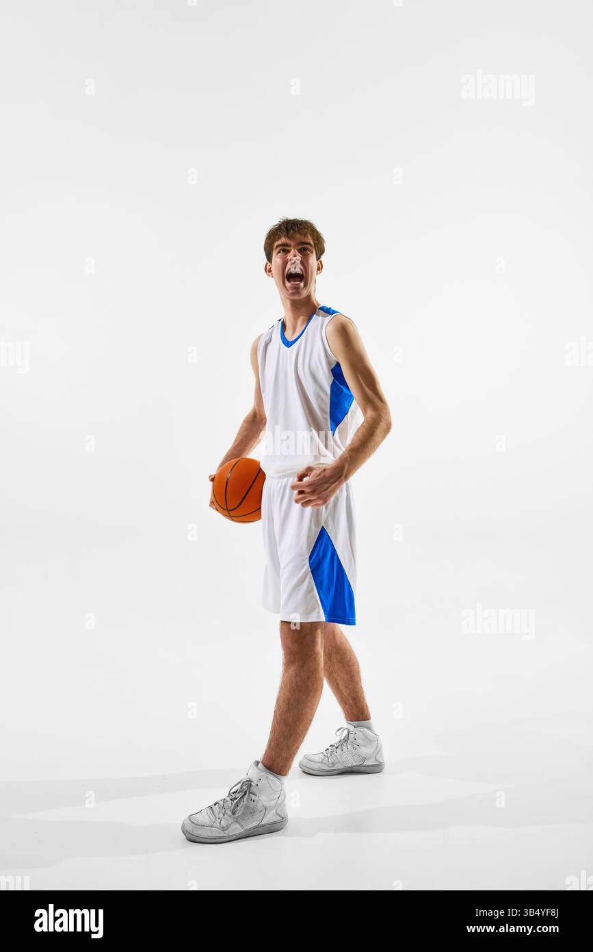 Full length photo of energetic young basketball player yelling in ...