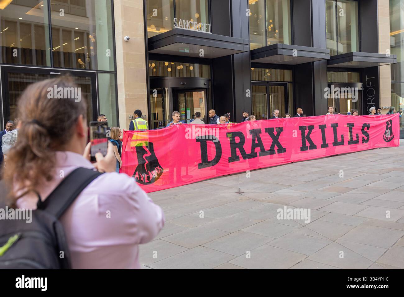 London, UK. 01 MAY, 2025. People take photos as "Drax kills" banner is ...