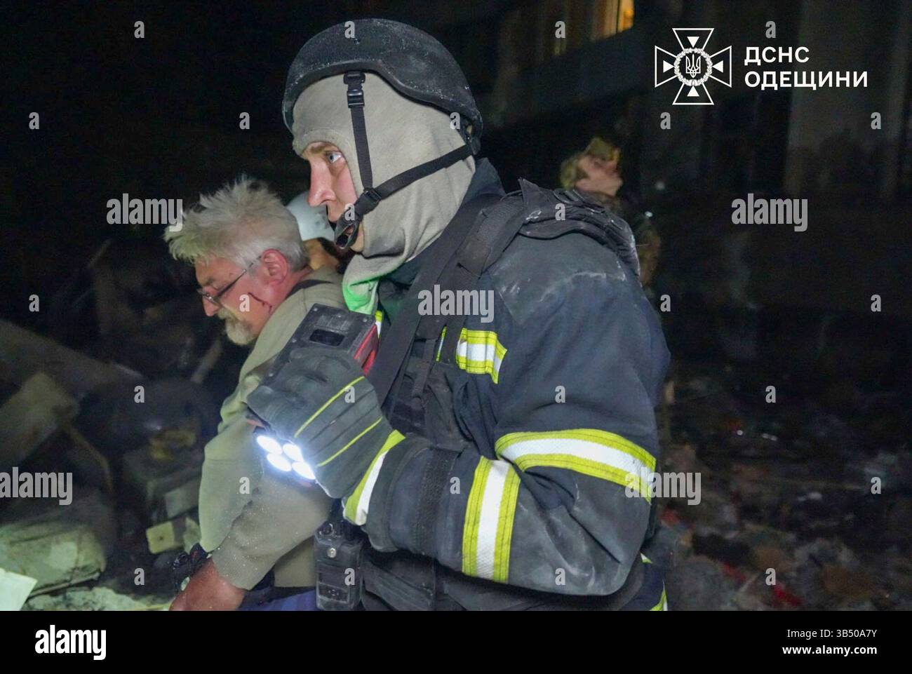 In this photo provided by the Ukrainian Emergency Service, a rescuer ...