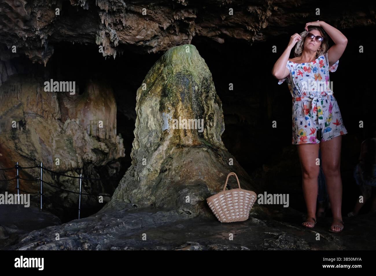 A female tourist adjusting her hair on holiday in caves, nature Stock ...