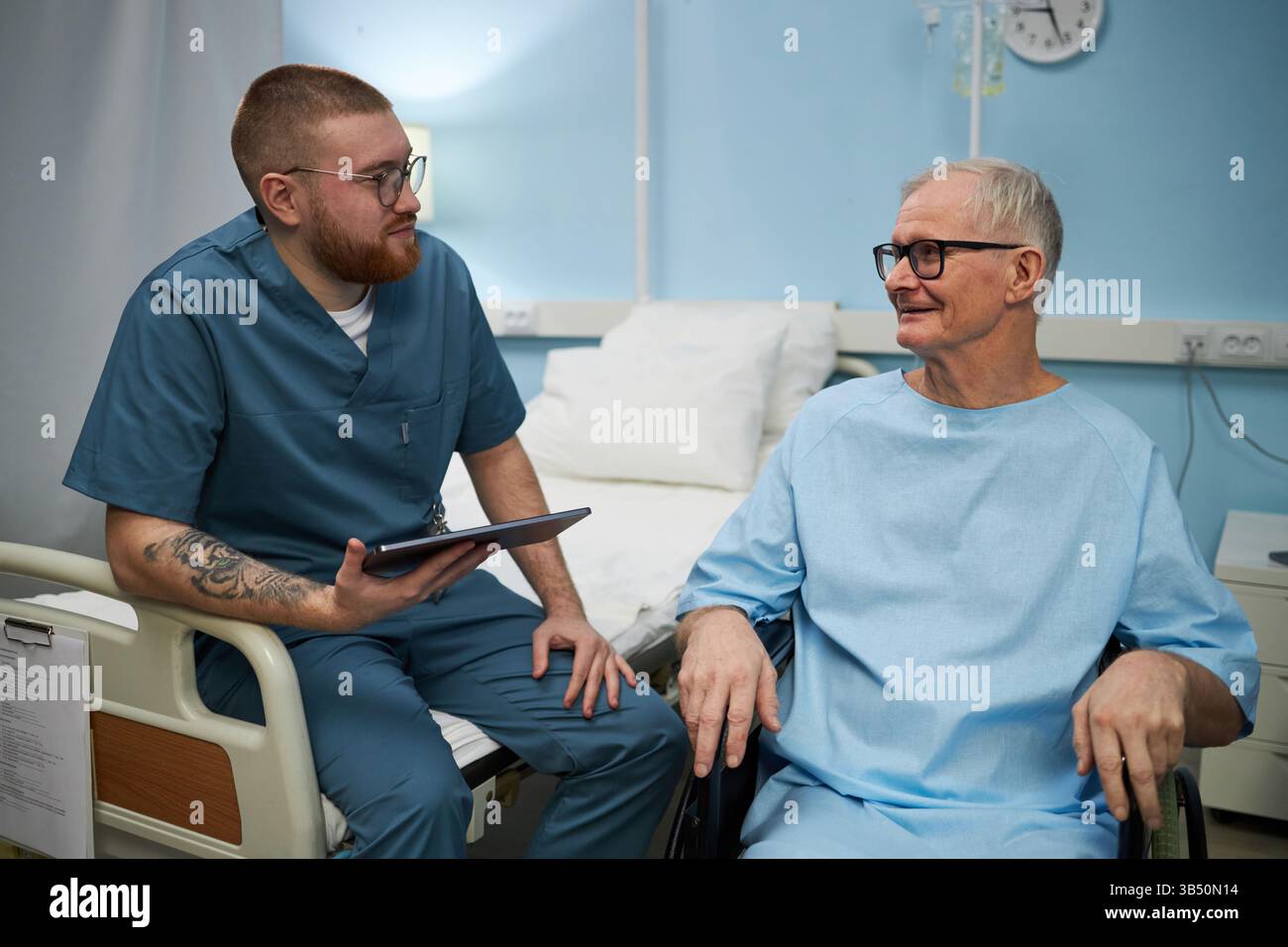 Medical Professional Engaging Senior Patient in Hospital Room Stock ...