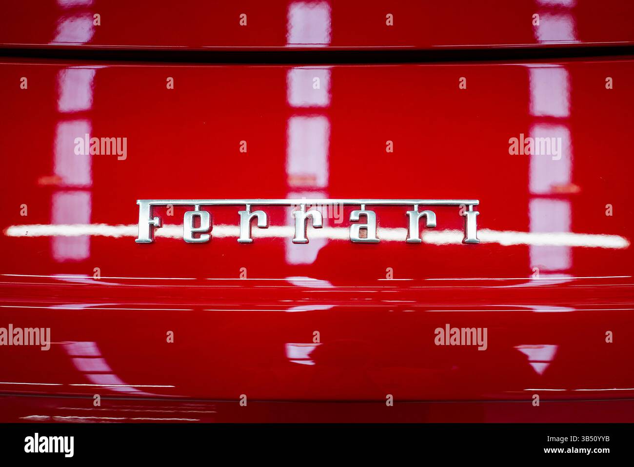 Ferrari logo in silver under strip lights Stock Photo - Alamy