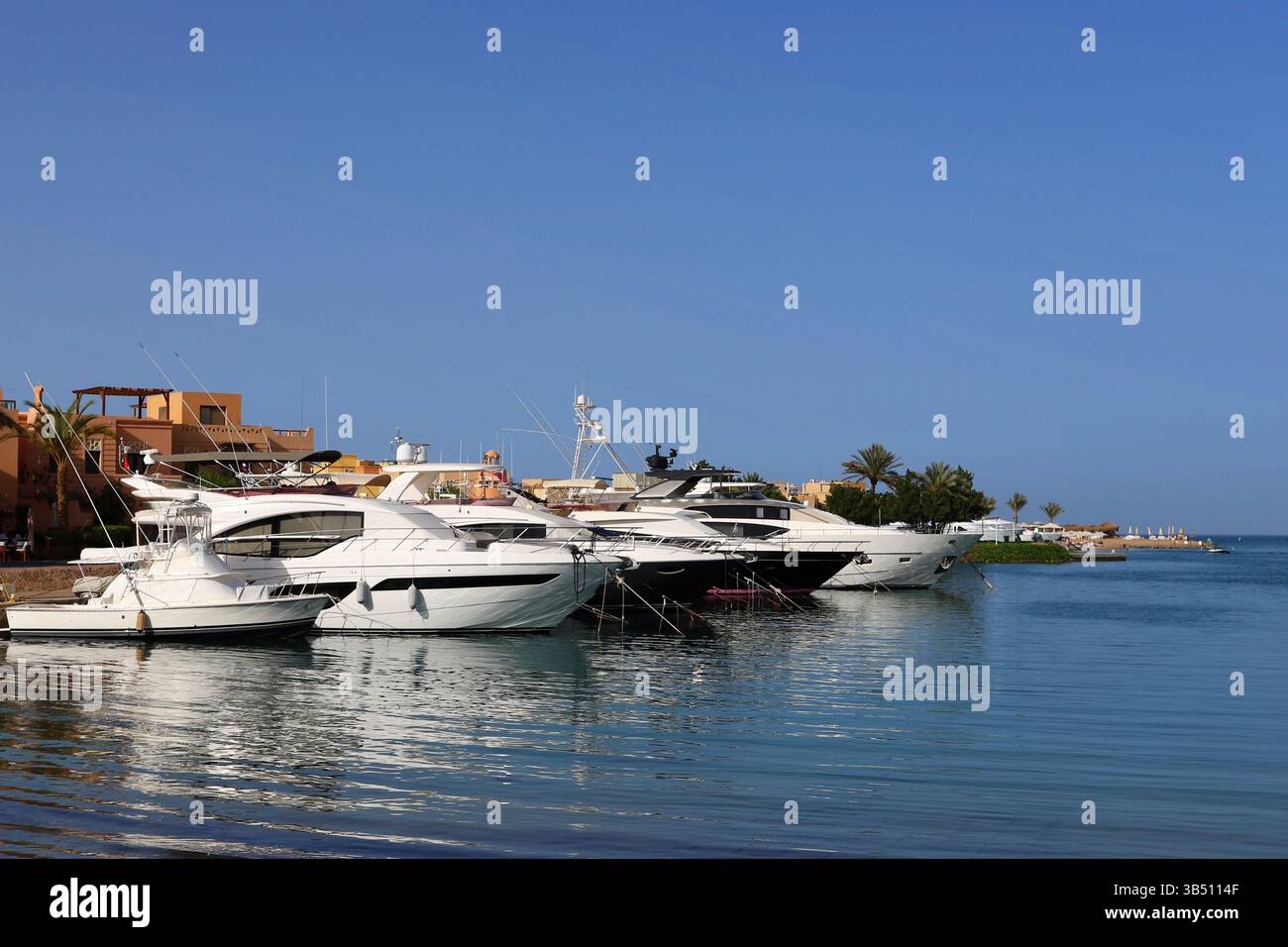 Luxury yachts docked at a marina in El Gouna, Egypt, with clear blue ...