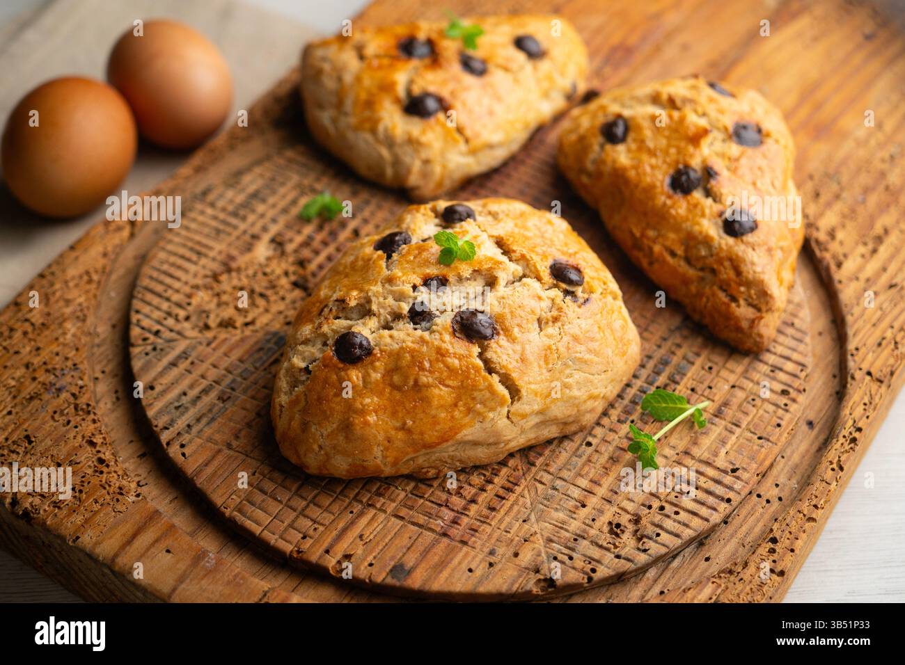 Triangular English scones with dark chocolate chips Stock Photo - Alamy
