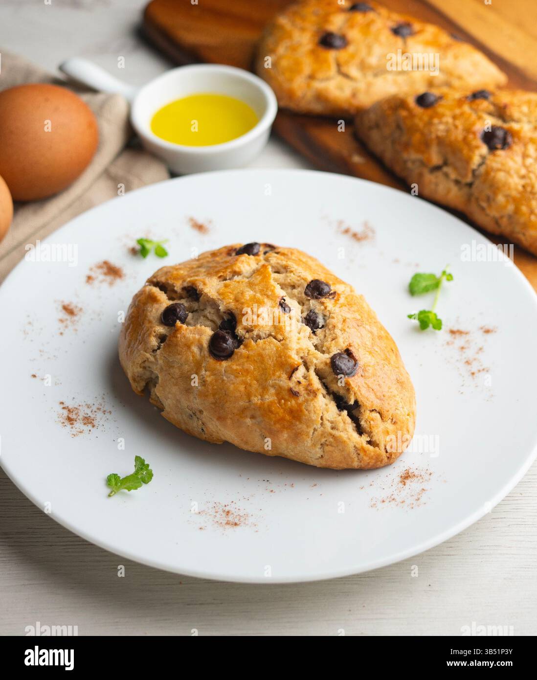Triangular English scones with dark chocolate chips Stock Photo - Alamy