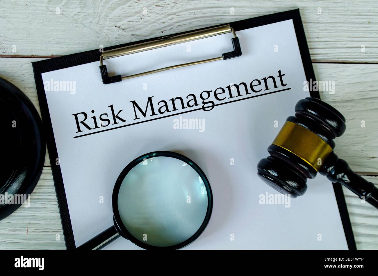 Top view of Risk management text on white paper clipboard with gavel ...