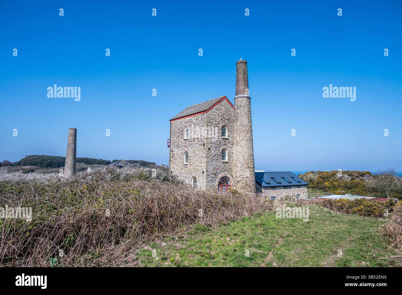 The image is of a restored, previously abandoned tin mine pump house on ...