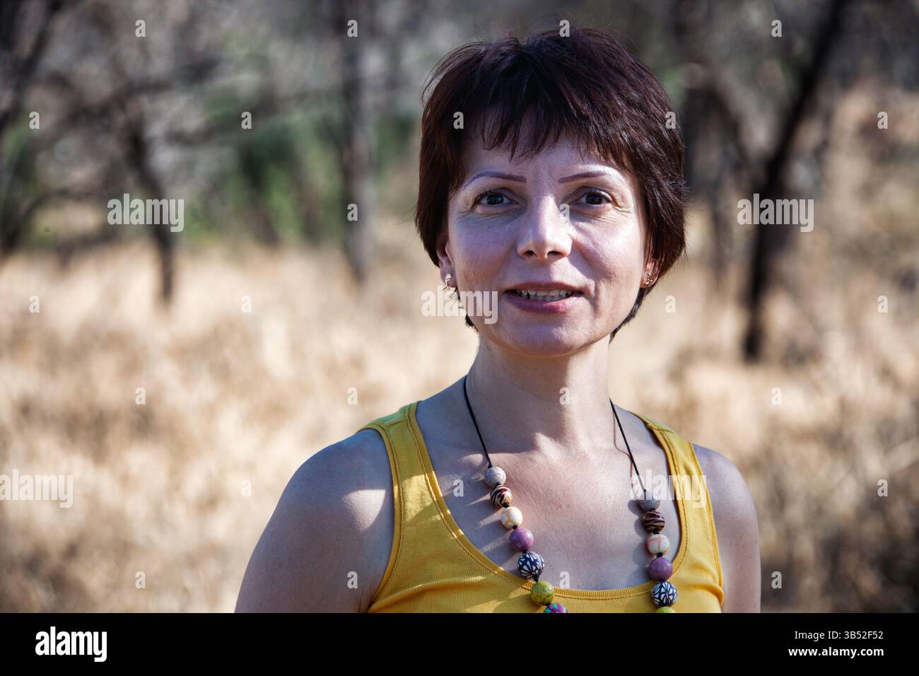 single woman with short hair outdoors in the nature head and shoulders ...