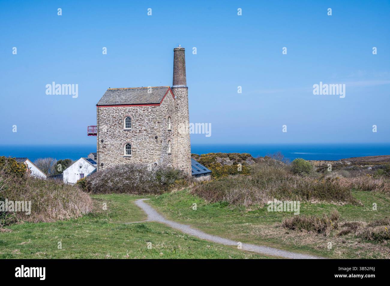 The image is of a restored, previously abandoned tin mine pump house on ...