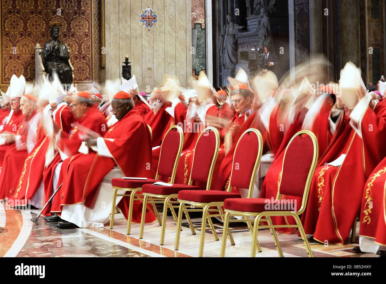 Cardinals wait for the start of a mass on the sixth of nine days of ...