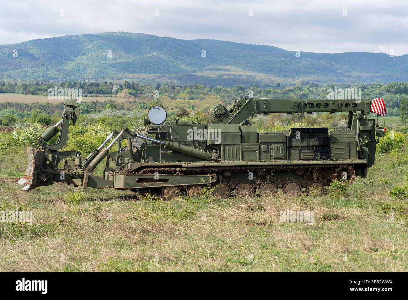 Green military engineering vehicle with crane and bulldozer blade Stock ...