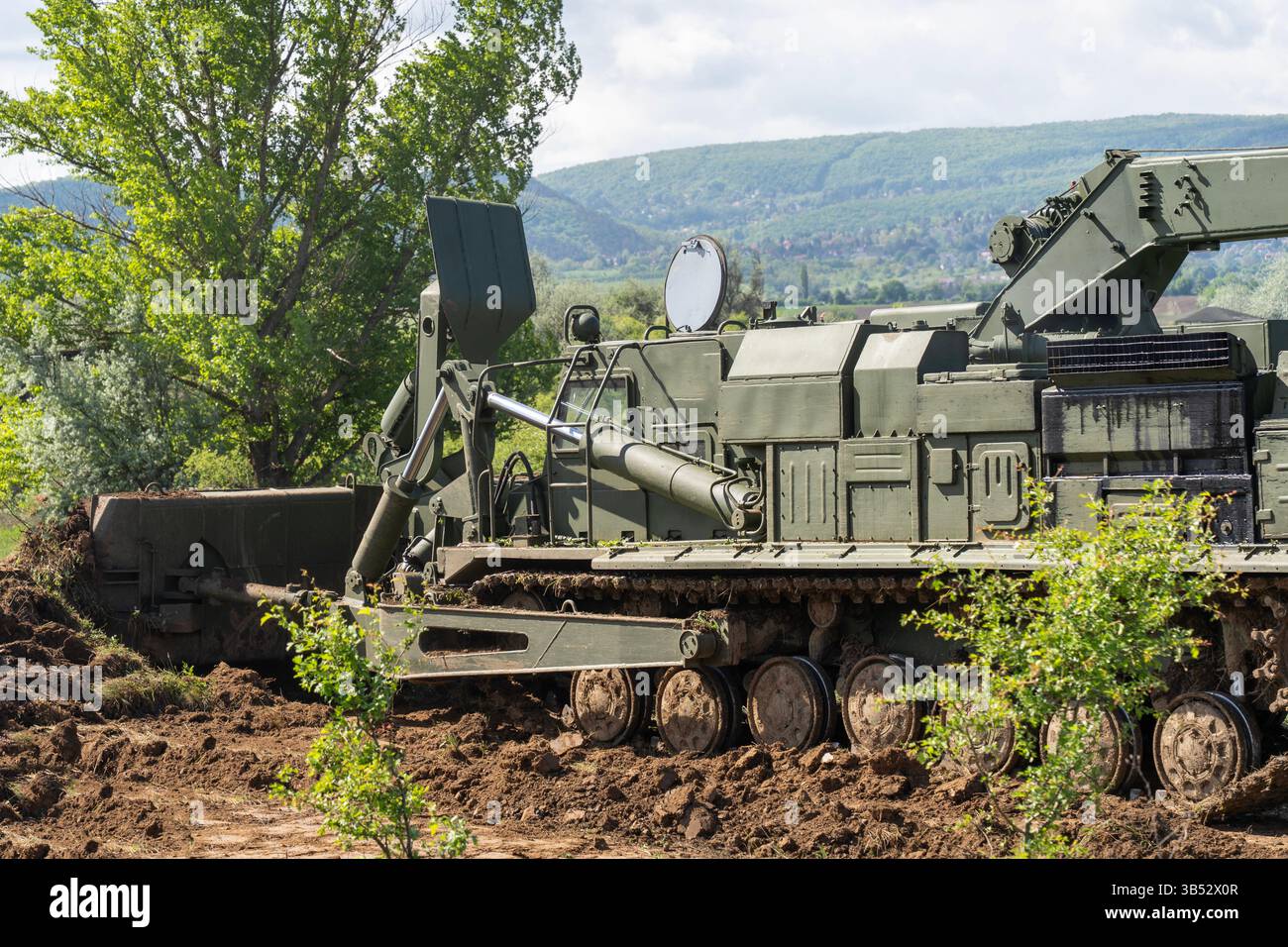 Green military engineering vehicle with crane and bulldozer blade Stock ...
