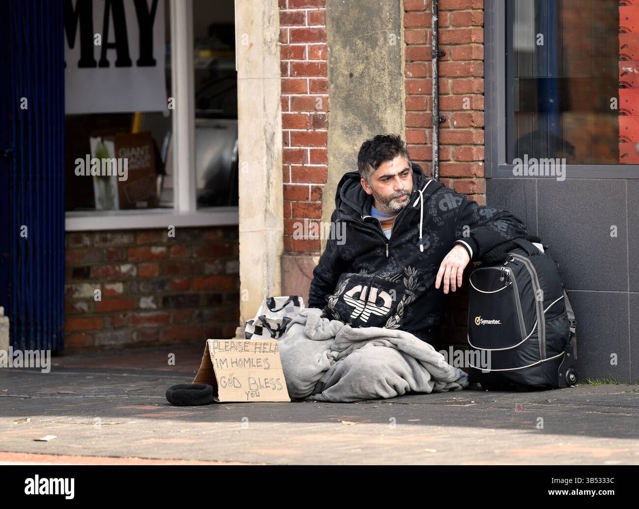 Homeless man begging on High Street, Alton, Hampshire, UK Stock Photo ...