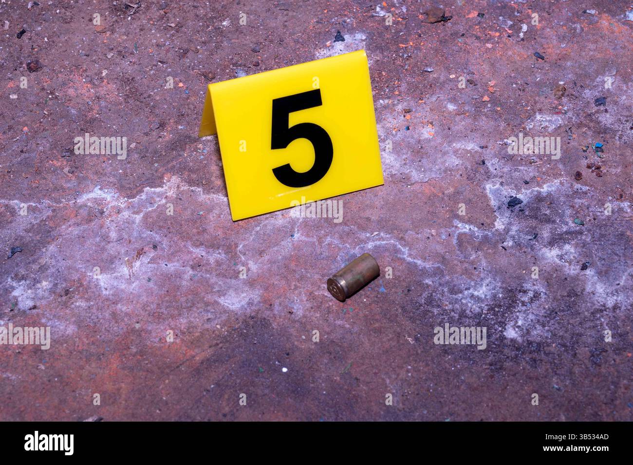 Bullet Casing with Yellow Evidence Marker Number 5 at Crime Scene Stock ...