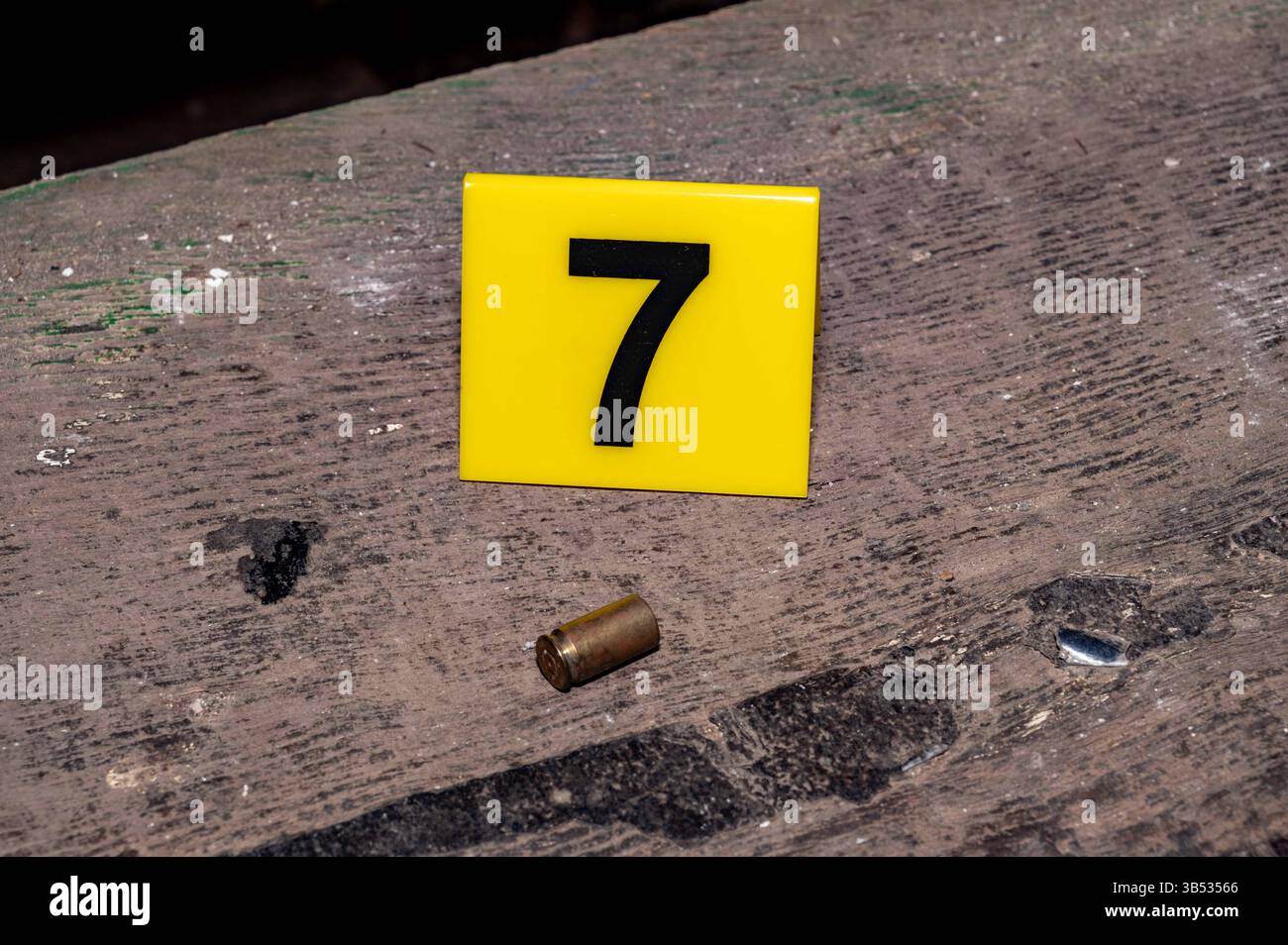 Bullet Casing with Yellow Evidence Marker Number 7 at Crime Scene Stock ...