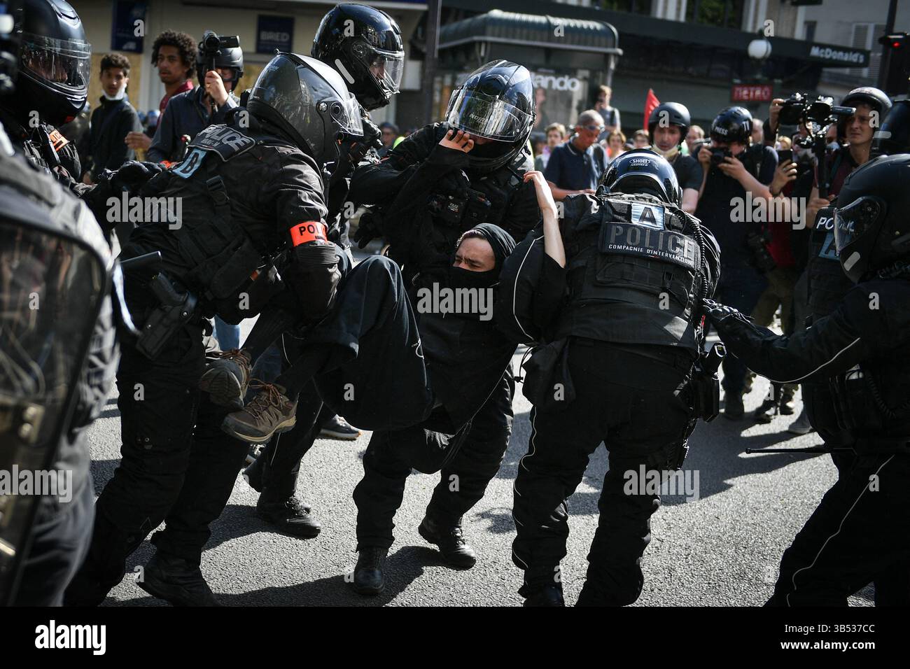 Riot police arrests a protester during the annual Labour Day rally on ...